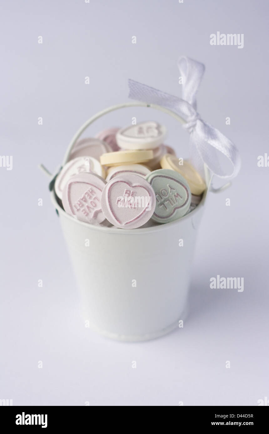 Love heart sweets in a little bucket with bow Stock Photo - Alamy