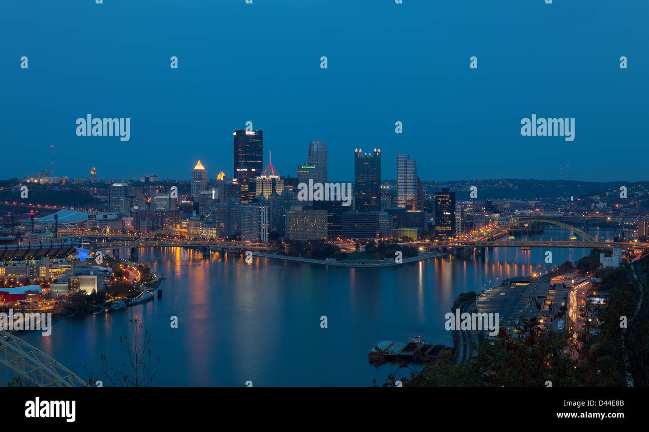 View of the city of Pittsburgh at sunset as building lights come on ...