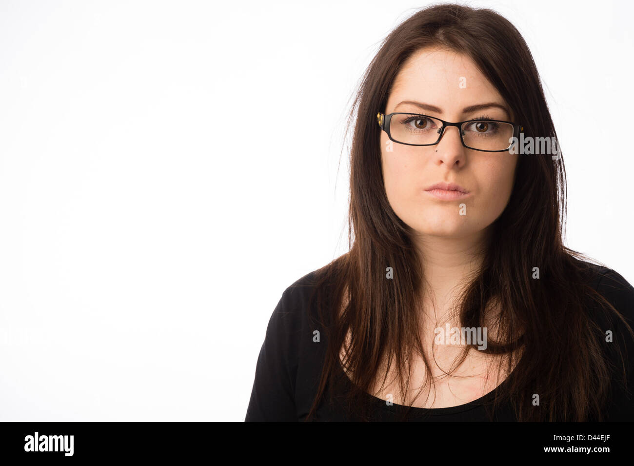 A young stern looking woman, brown hair, wearing spectacles glasses UK ...