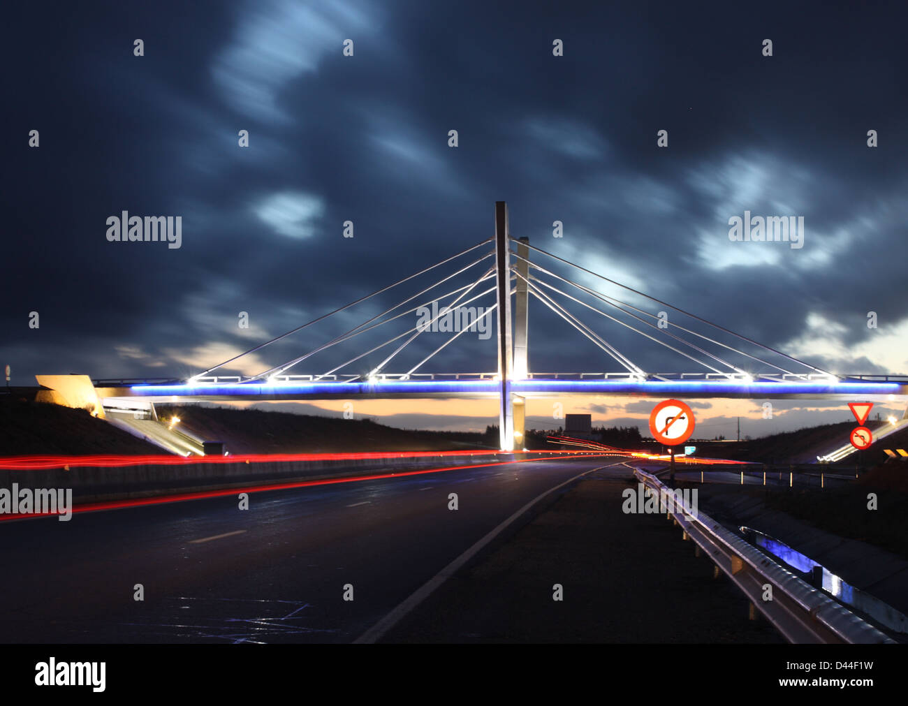 suspension bridge on highway with clouds after sunset Stock Photo - Alamy