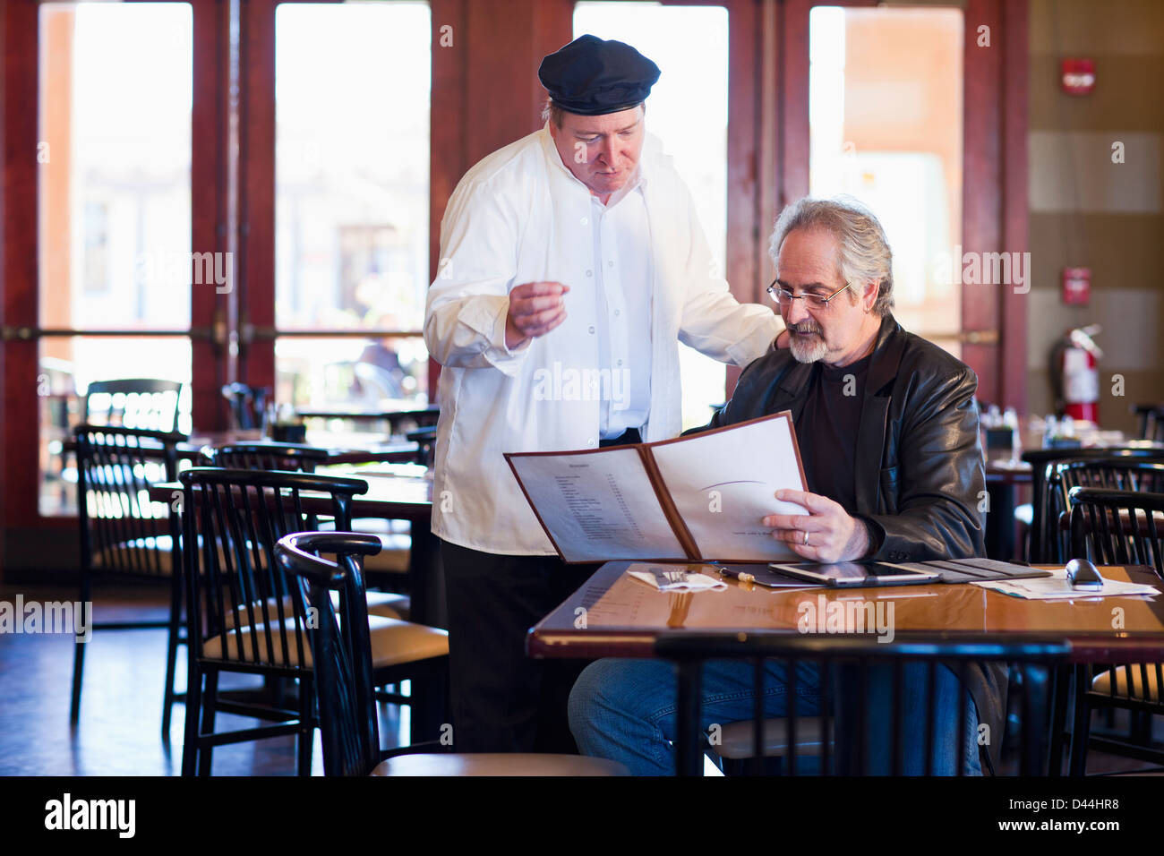 Caucasian man talking to chef in restaurant Stock Photo - Alamy