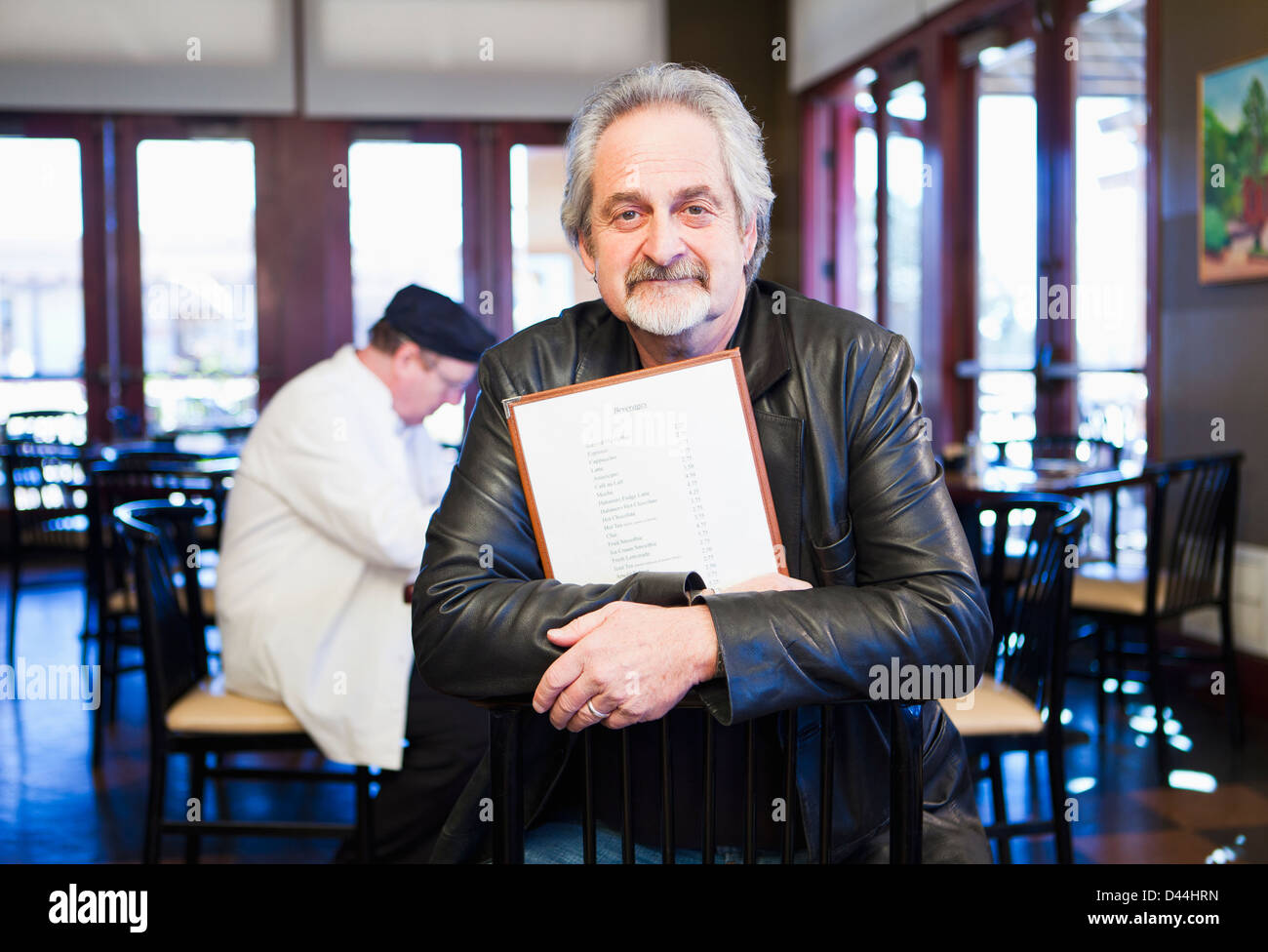 Caucasian man holding menu in restaurant Stock Photo - Alamy