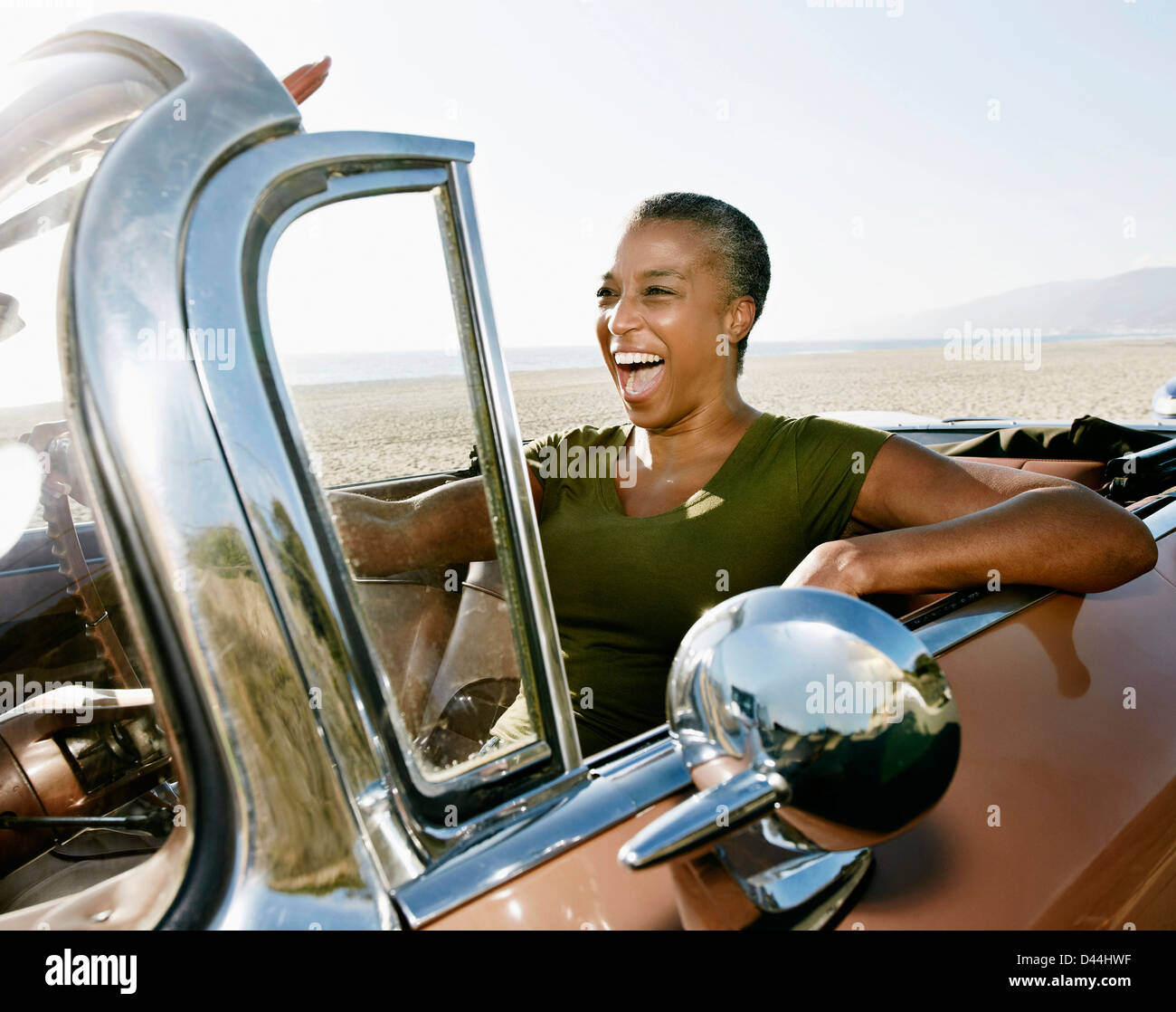 Black woman driving convertible Stock Photo - Alamy