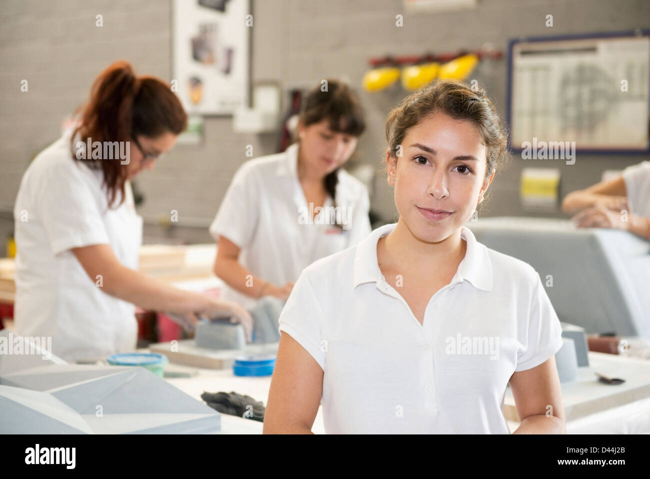 Worker smiling in manufacturing plant Stock Photo - Alamy
