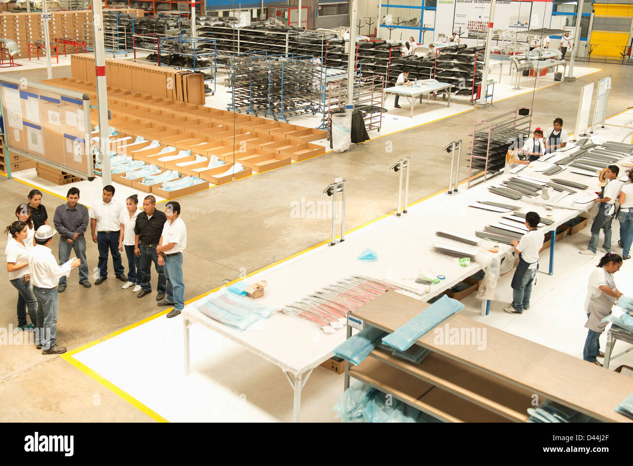 Workers talking in manufacturing plant Stock Photo - Alamy