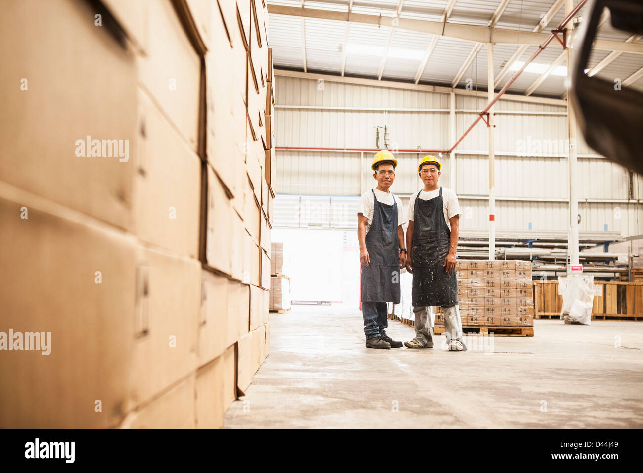 Workers standing in manufacturing plant Stock Photo - Alamy