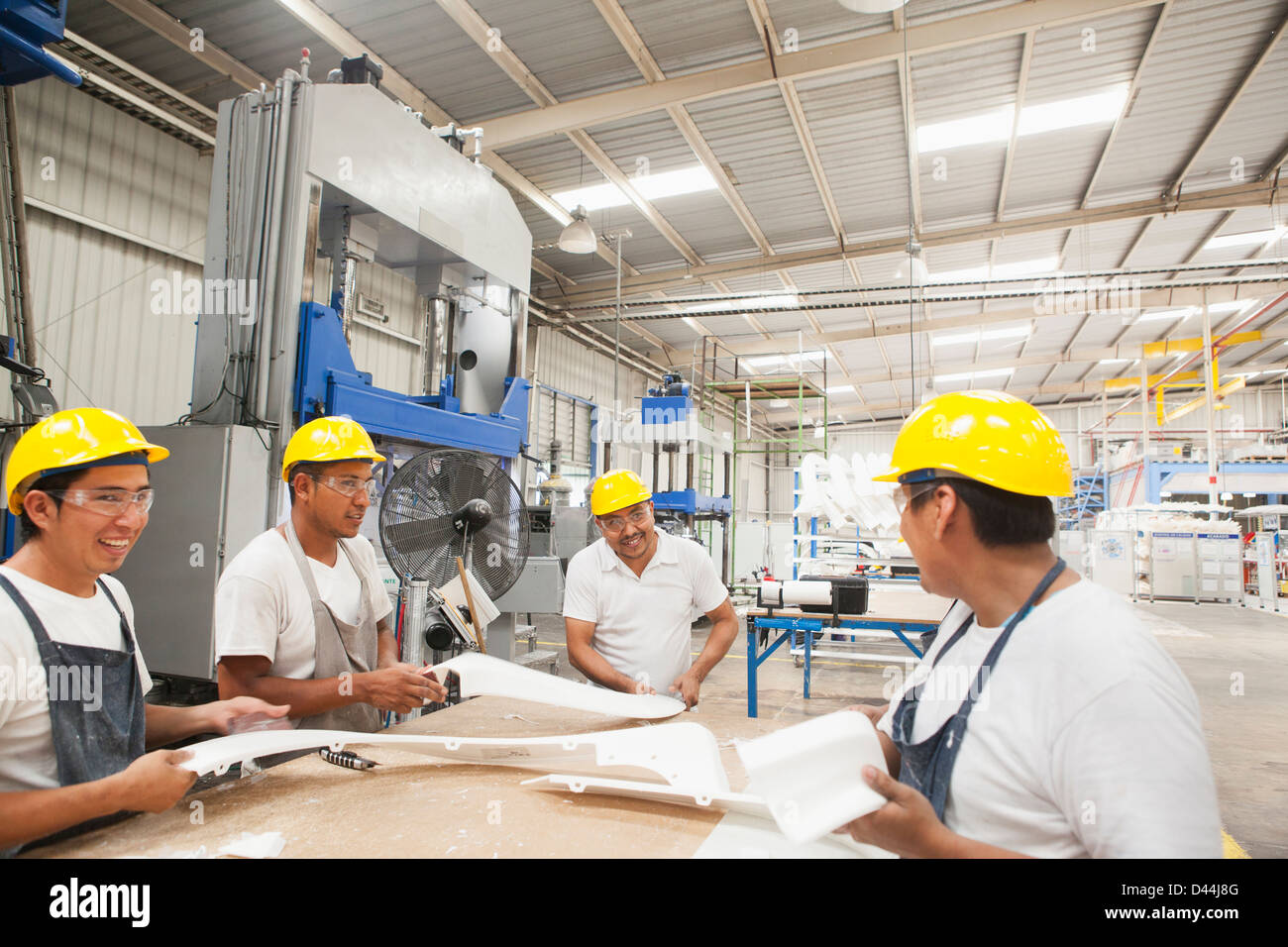 Workers talking in manufacturing plant Stock Photo - Alamy