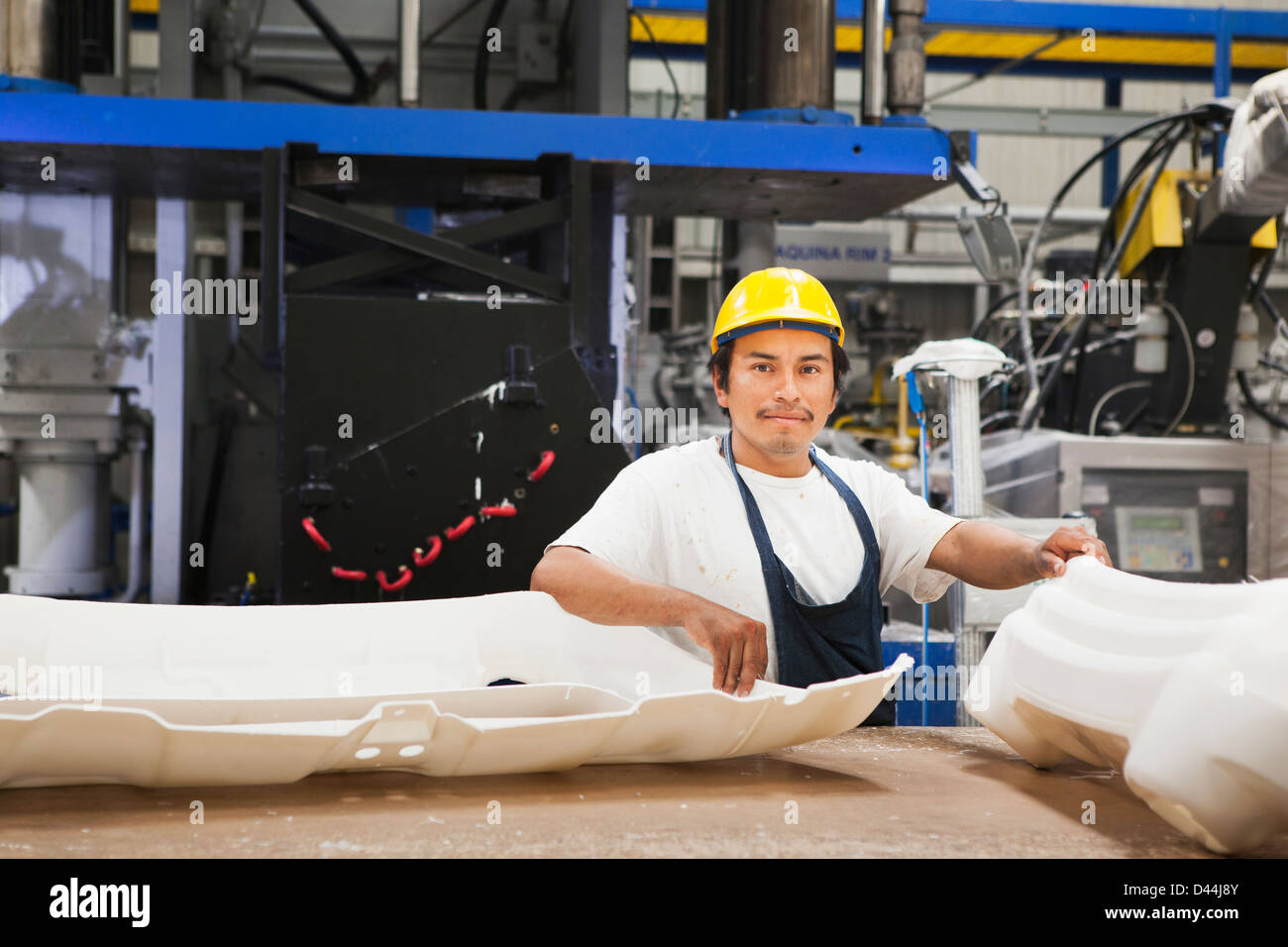Worker smiling in manufacturing plant Stock Photo - Alamy