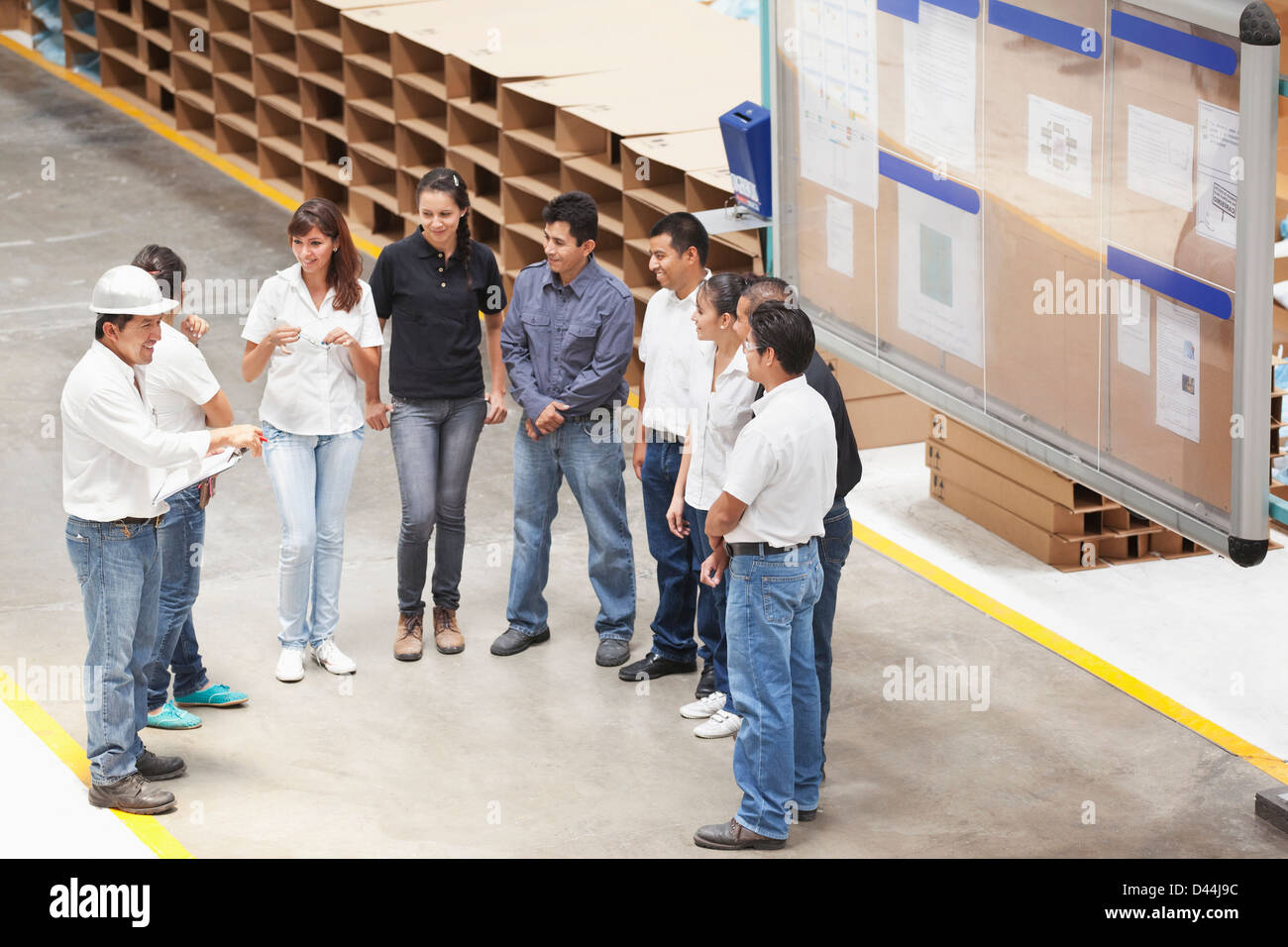 Workers talking in manufacturing plant Stock Photo - Alamy