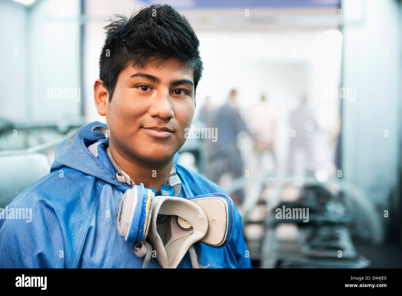 Worker smiling in manufacturing plant Stock Photo - Alamy
