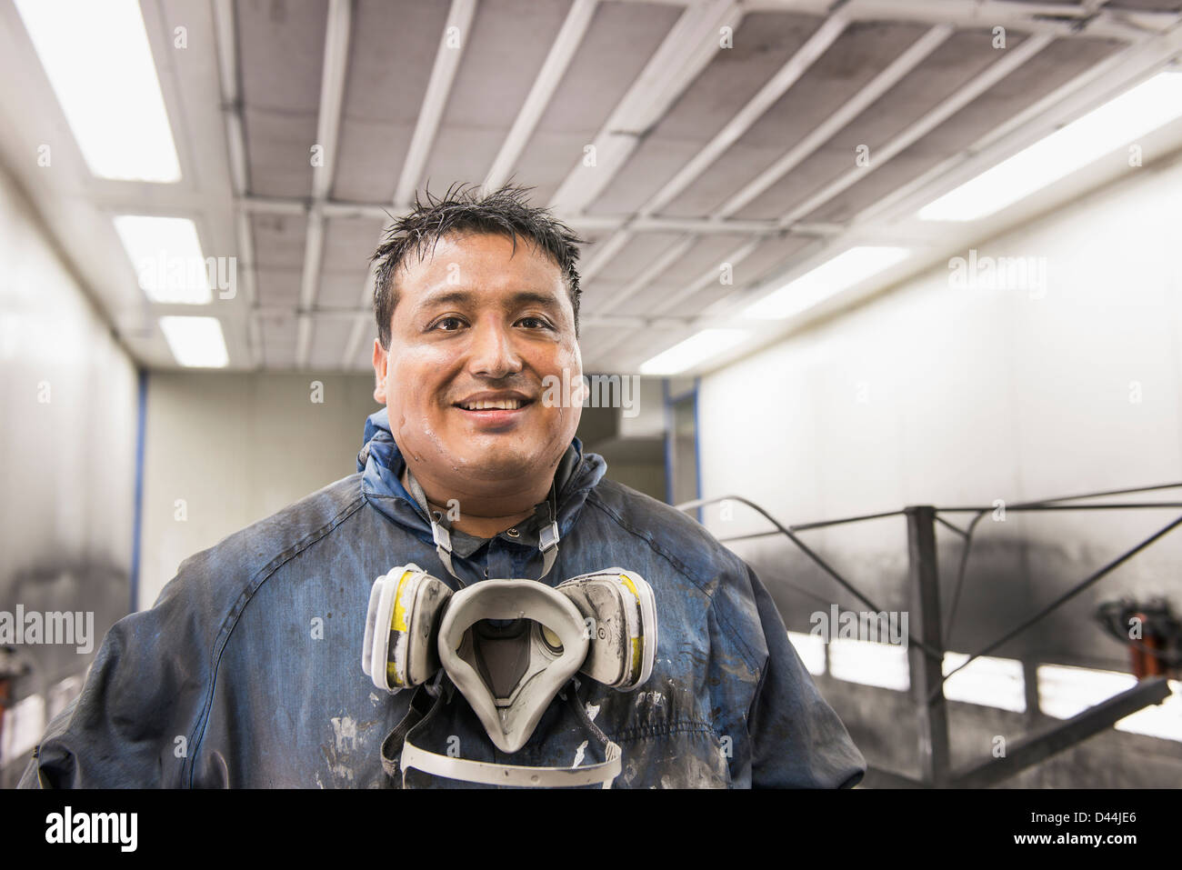 Worker smiling in manufacturing plant Stock Photo - Alamy