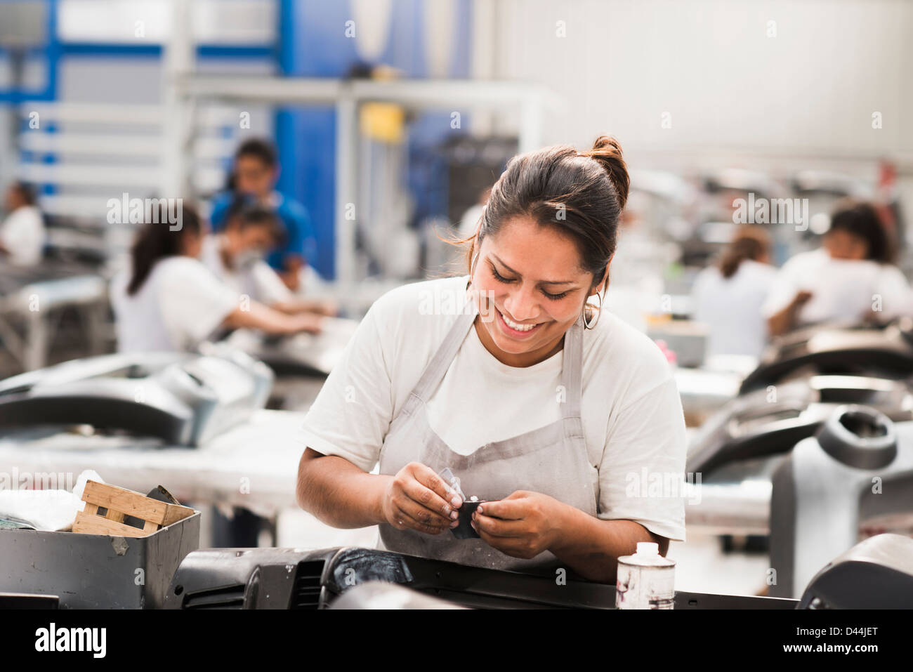 Worker smiling in manufacturing plant Stock Photo - Alamy