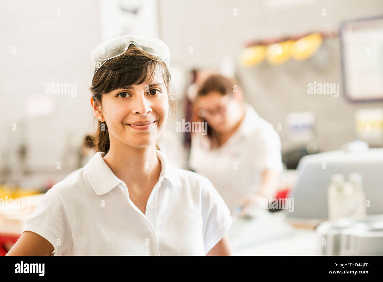 Worker smiling in manufacturing plant Stock Photo - Alamy