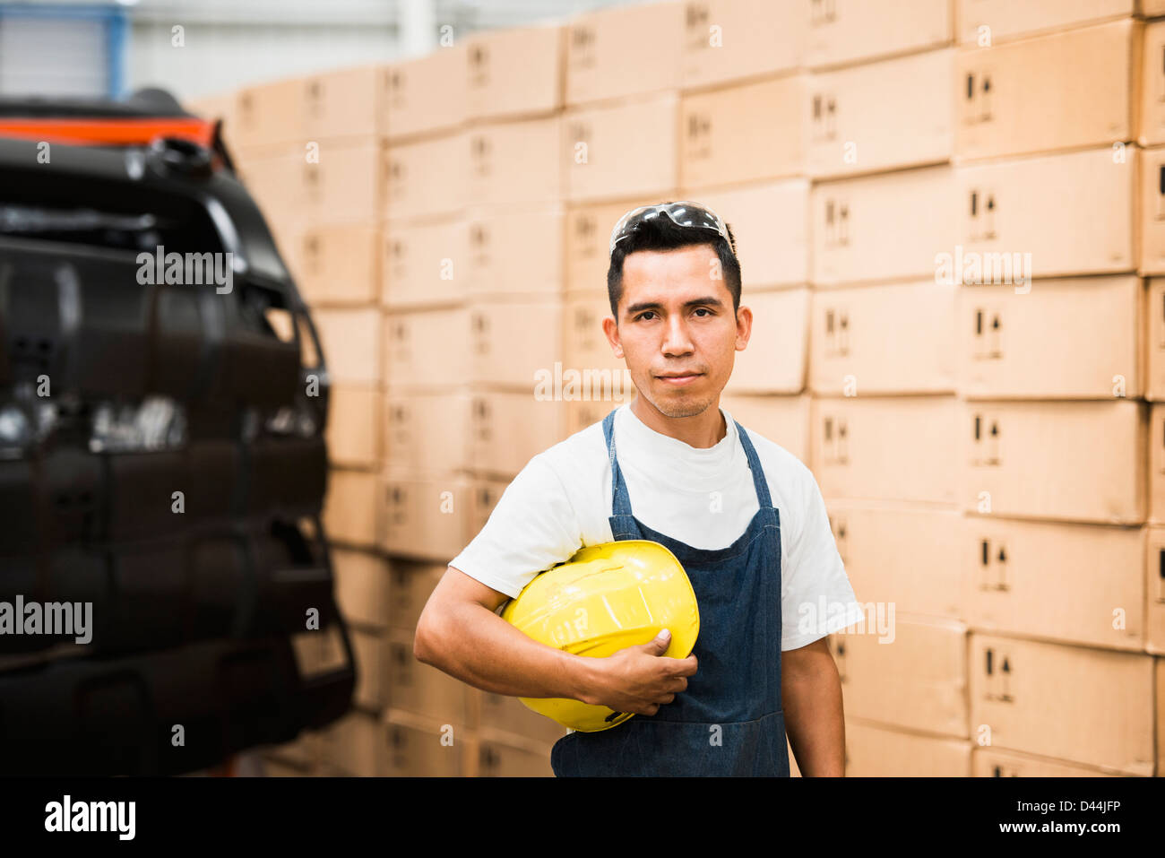 Worker standing in manufacturing plant Stock Photo - Alamy