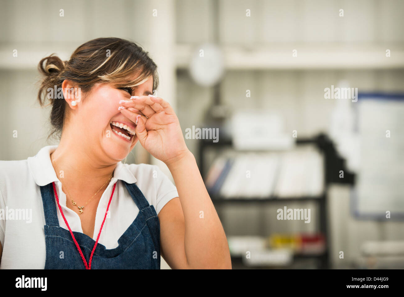 Worker laughing in manufacturing plant Stock Photo - Alamy