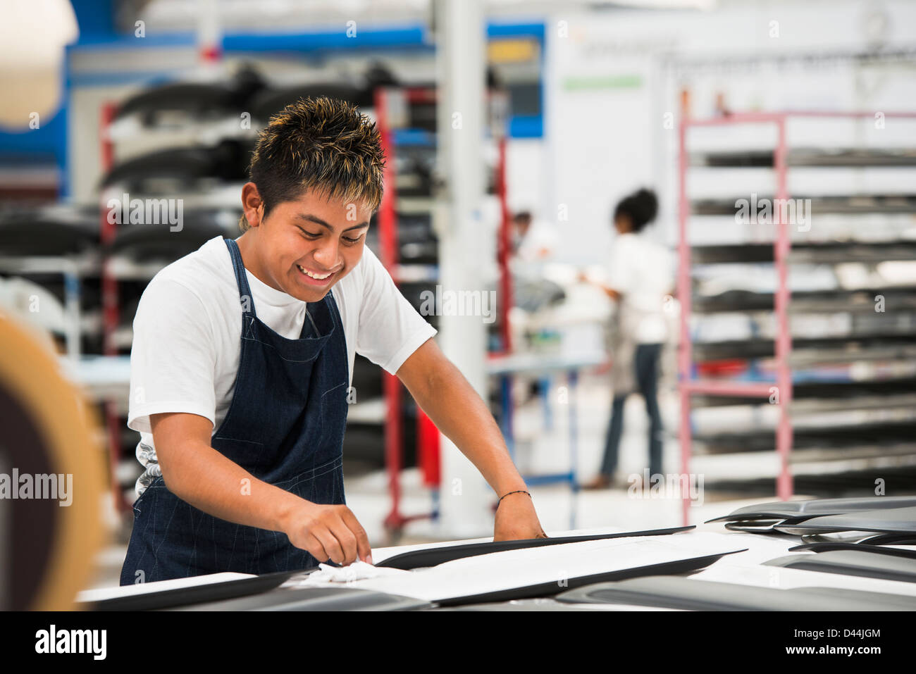 Worker smiling in manufacturing plant Stock Photo - Alamy