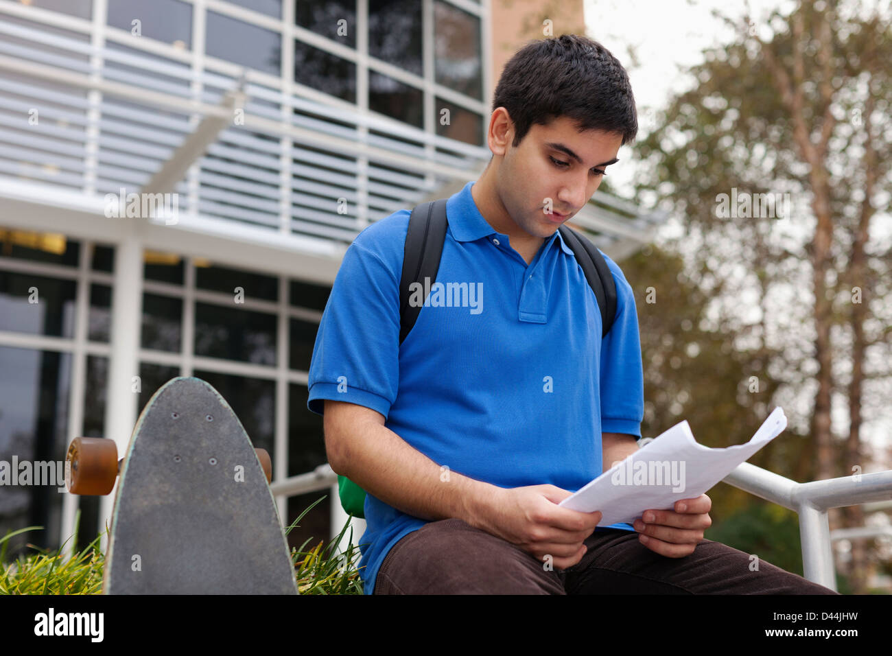 Middle Eastern student reading notes on campus Stock Photo - Alamy
