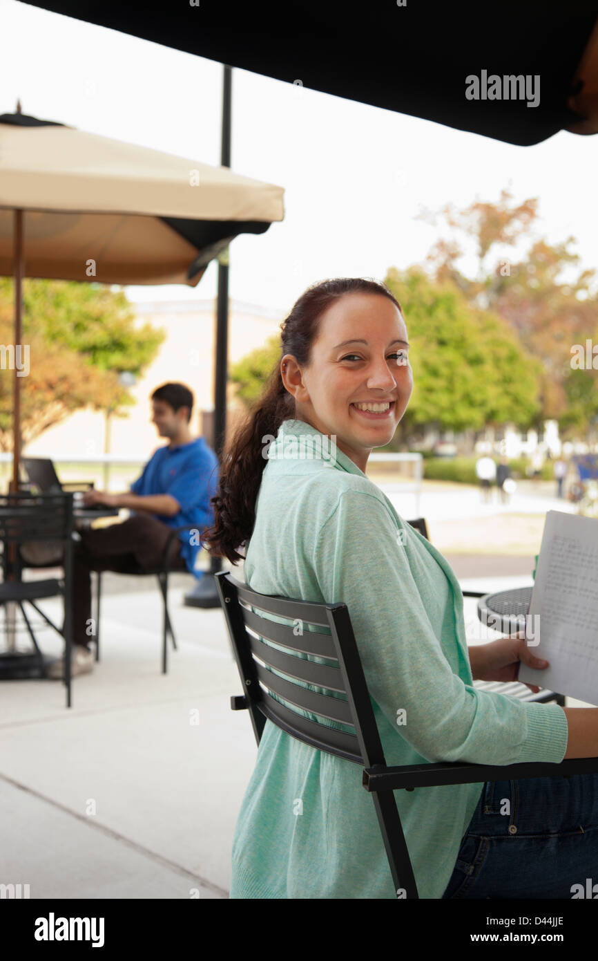 Students studying at tables on campus Stock Photo - Alamy