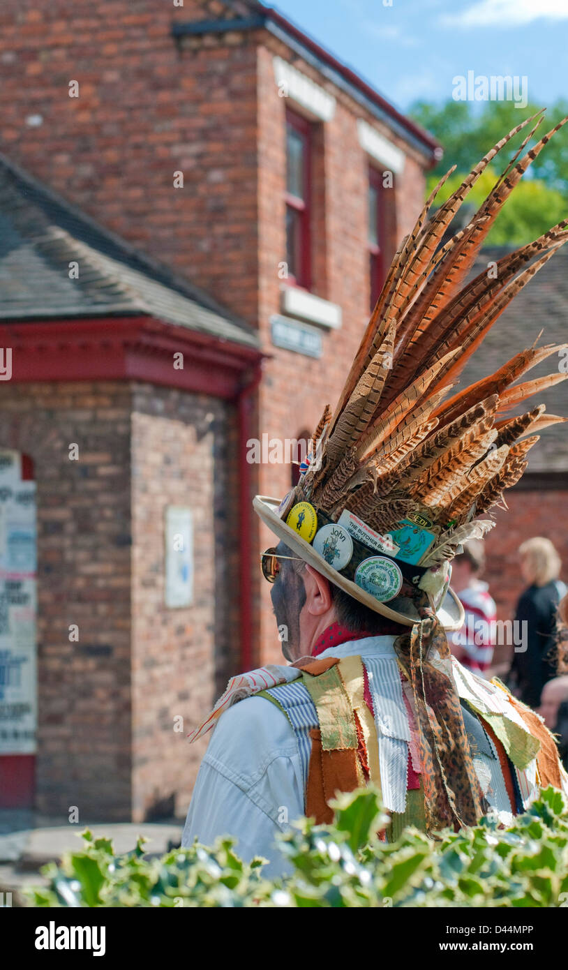 Morris dancer with painted face and feather hat Stock Photo - Alamy