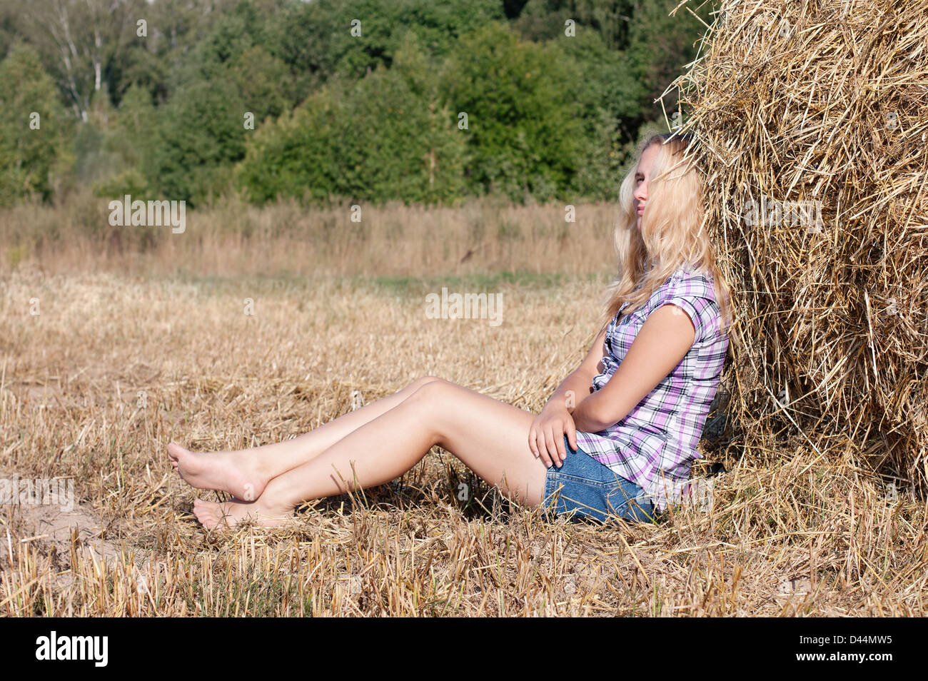 girl sitting on hay Stock Photo - Alamy