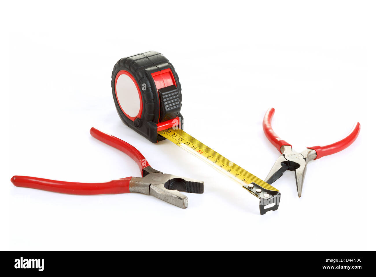 two different red pliers and measuring tape isolated on white Stock ...