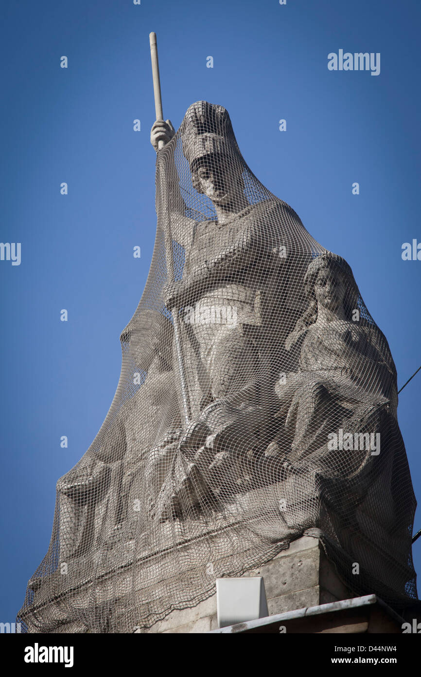 Netting protects statues from birds on the roof of Gibson Hall in the ...