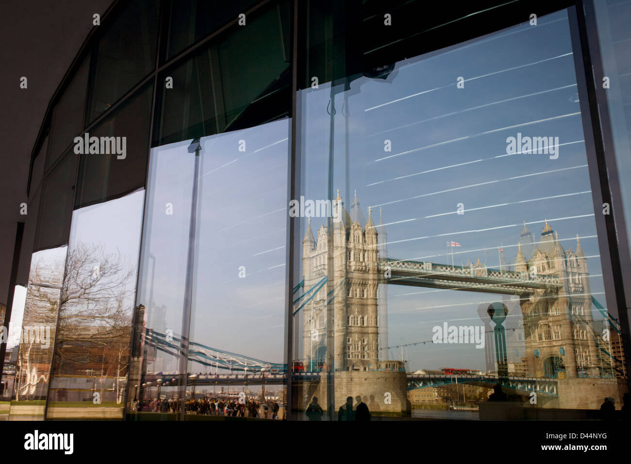 The Victorian Tower Bridge is seen reflected in the large glass windows ...
