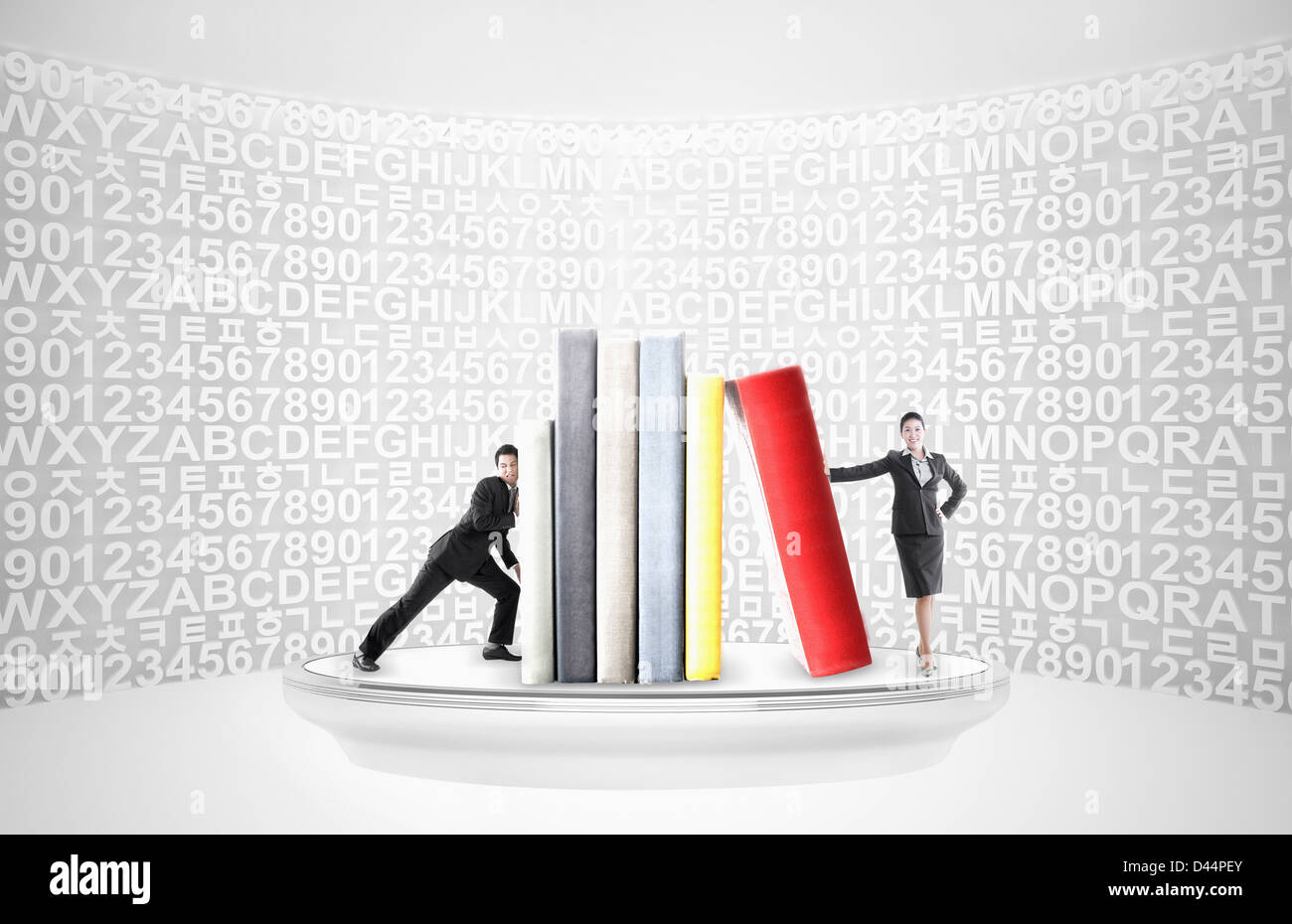 woman and man pushing each side of books Stock Photo - Alamy