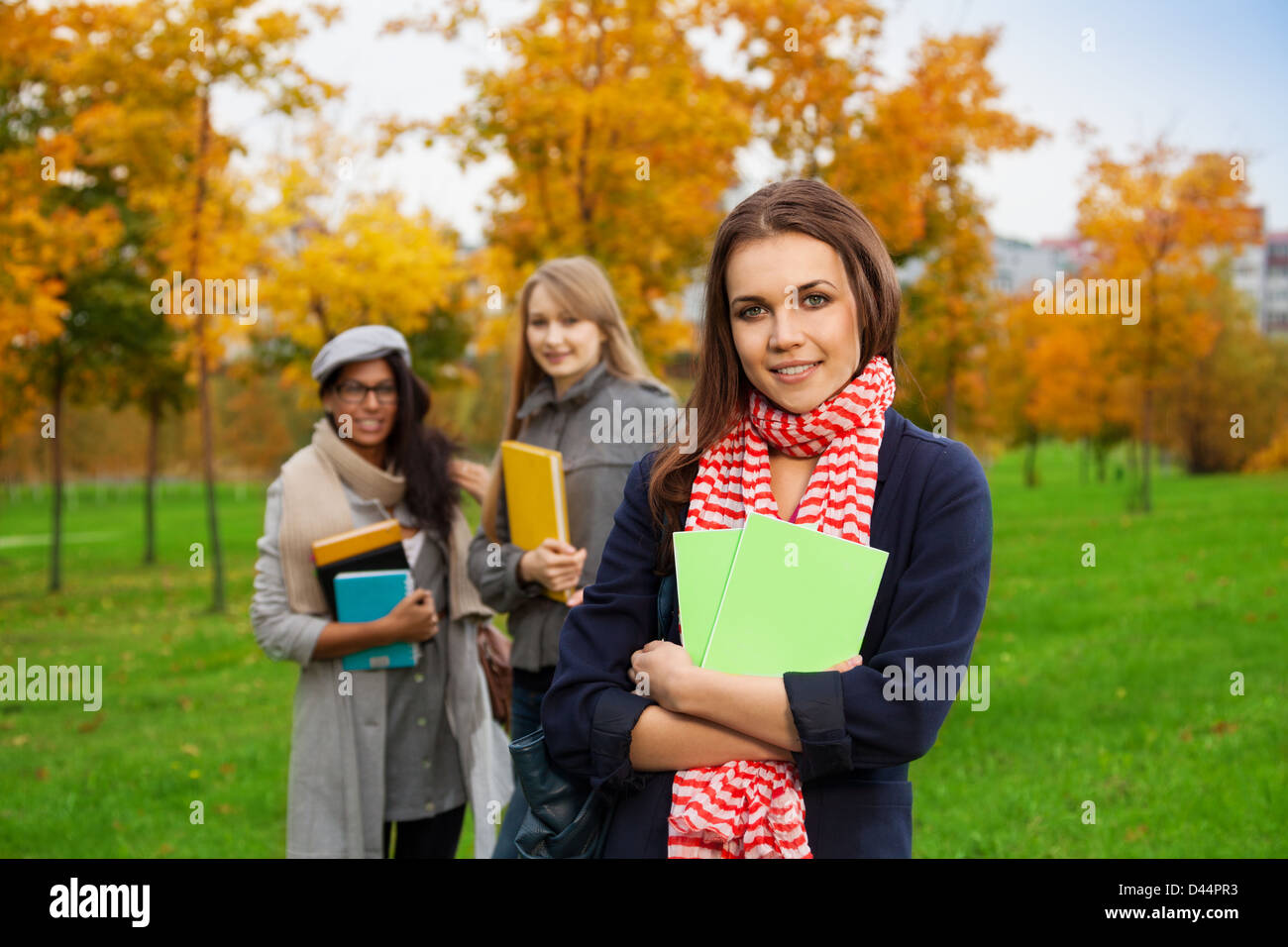smiling students standing in park Stock Photo - Alamy
