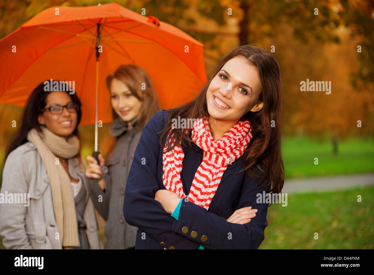 group of friends walking in autumn park Stock Photo - Alamy