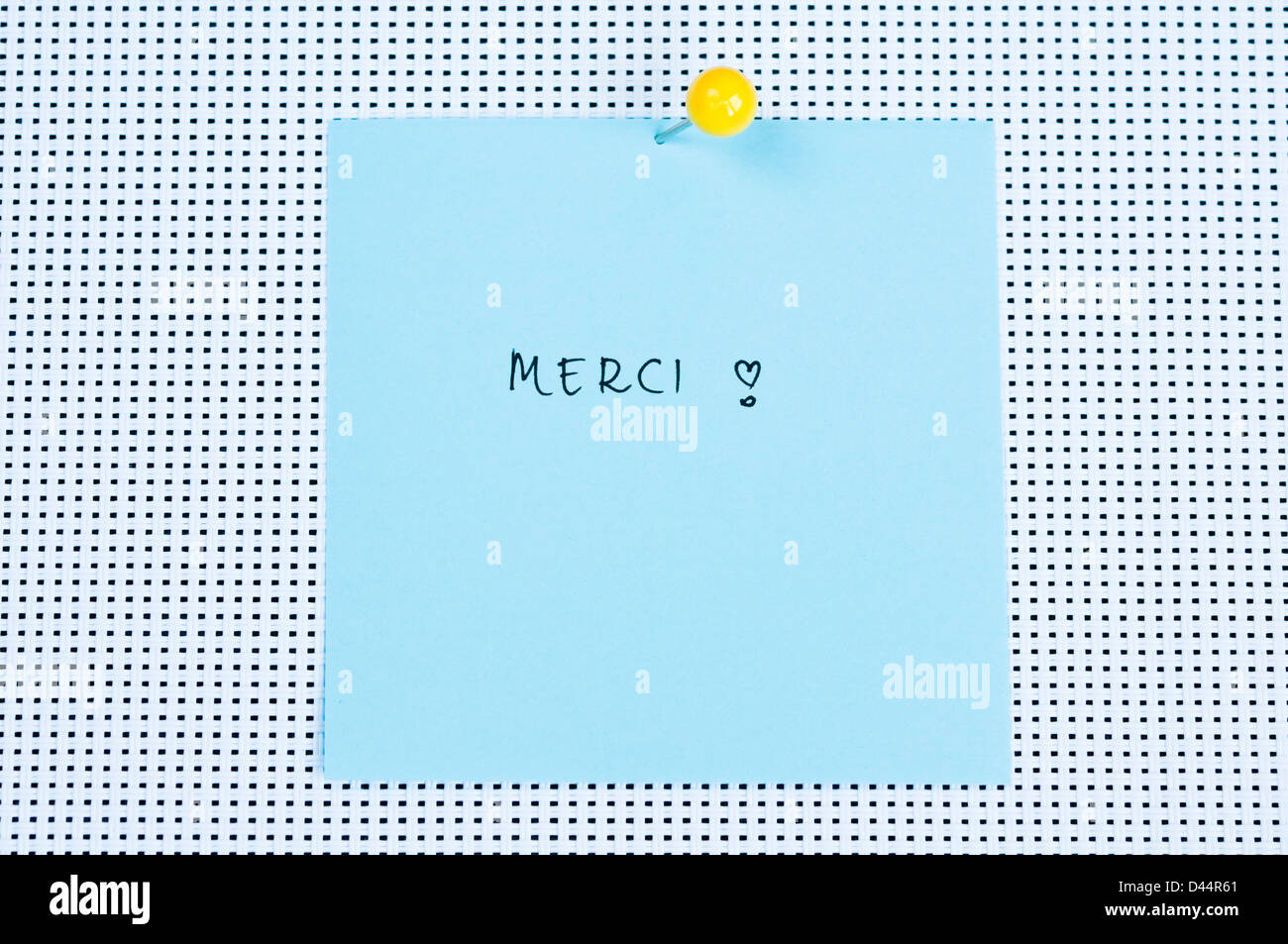 Postit note saying Merci arranged on black and white background Stock ...