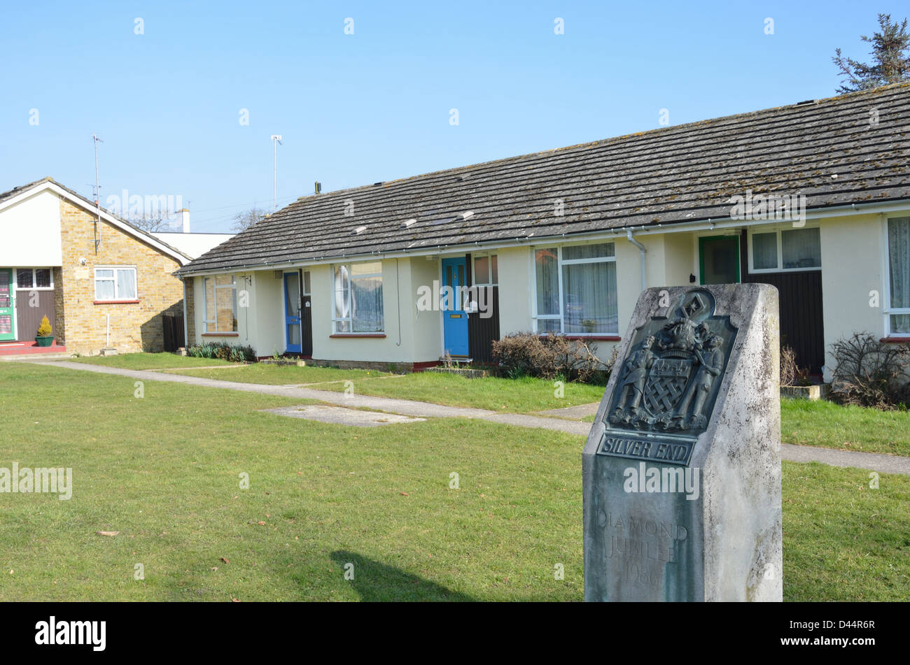 Silver end memorial stone and houses Stock Photo - Alamy