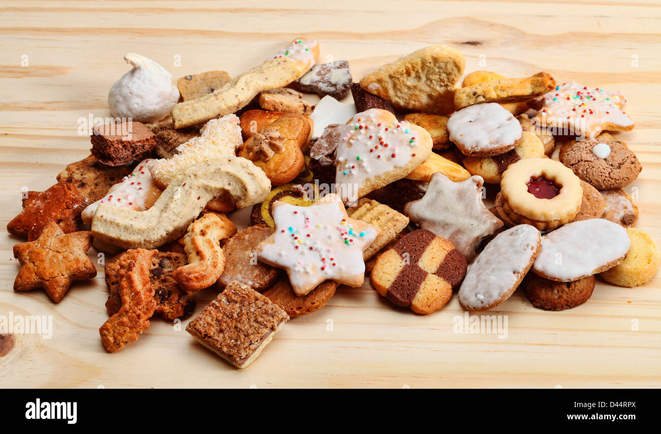 Stack of various brown biscuits and cookies on a wooden table Stock ...