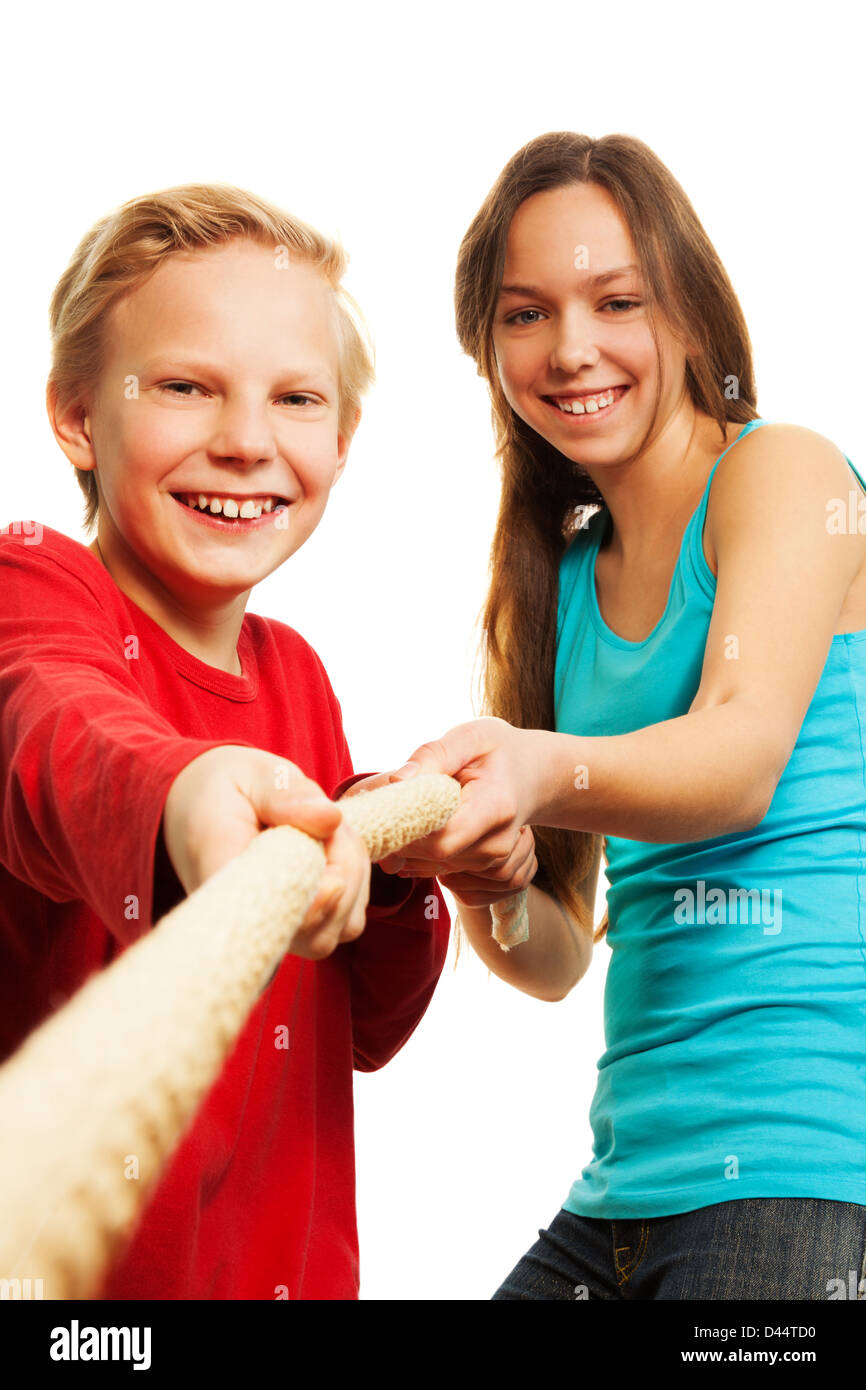 team of 11 years old blond boy and older girl pulling the rope in ...