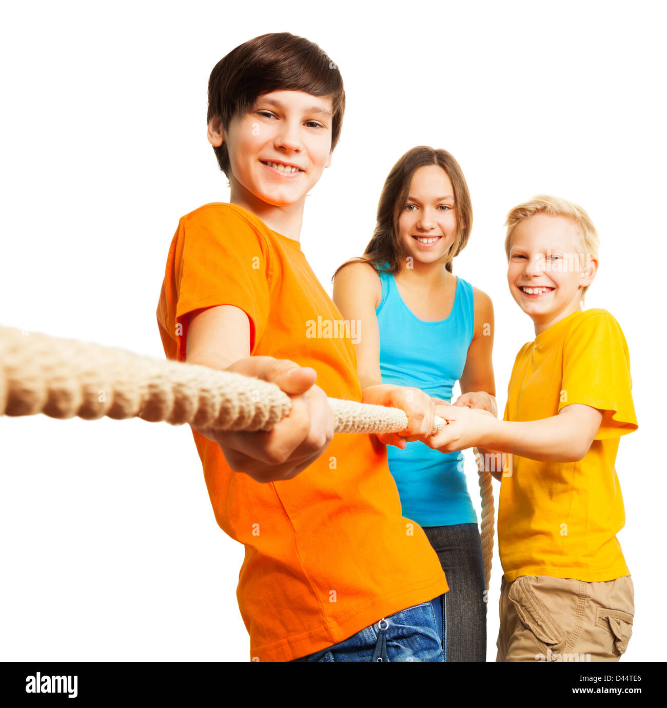 Team concept three happy kids pull the rope Stock Photo - Alamy