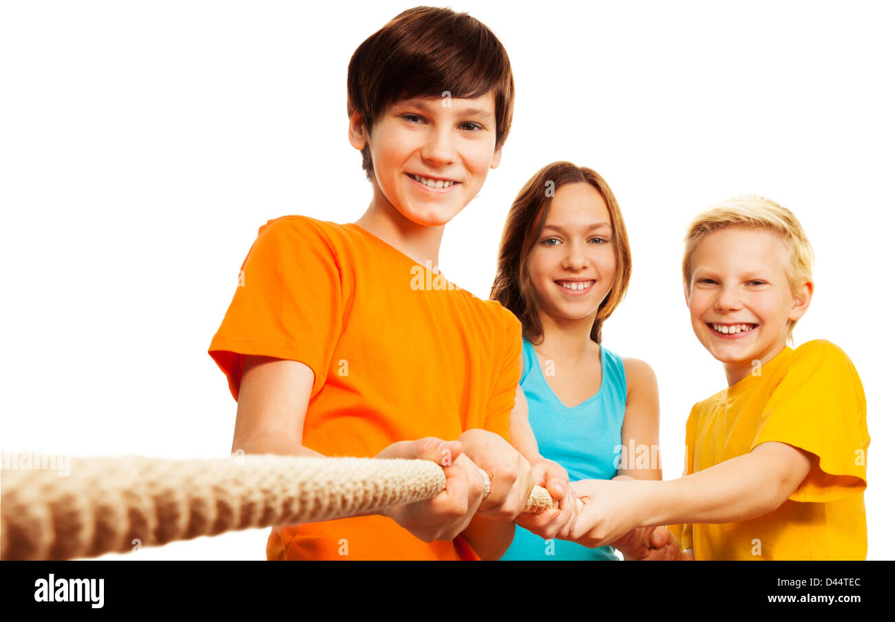 Teamwork - three kids pulling the rope with smile Stock Photo - Alamy