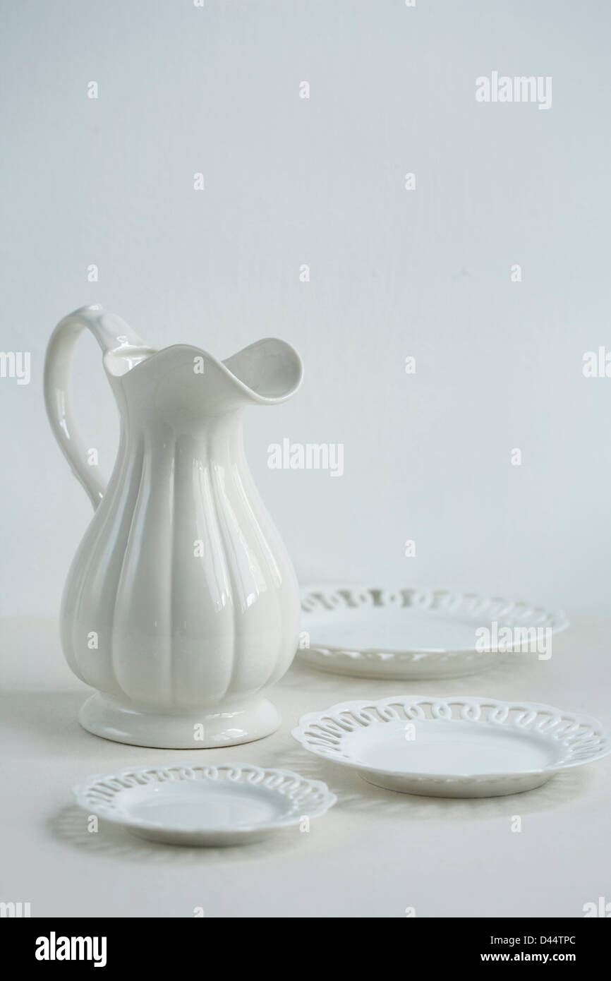 white plates and a jar Stock Photo - Alamy