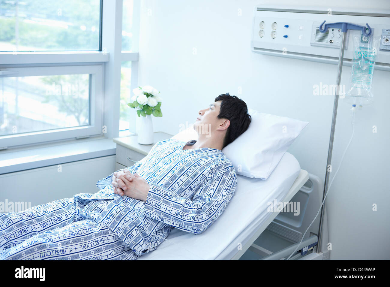 a patient lying on the bed in hospital room peacefully Stock Photo - Alamy