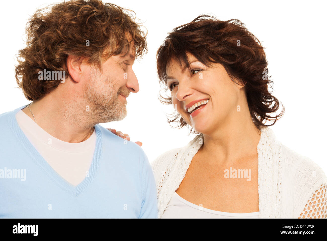 Happy adult couple smiling and looking in each others eyes Stock Photo ...