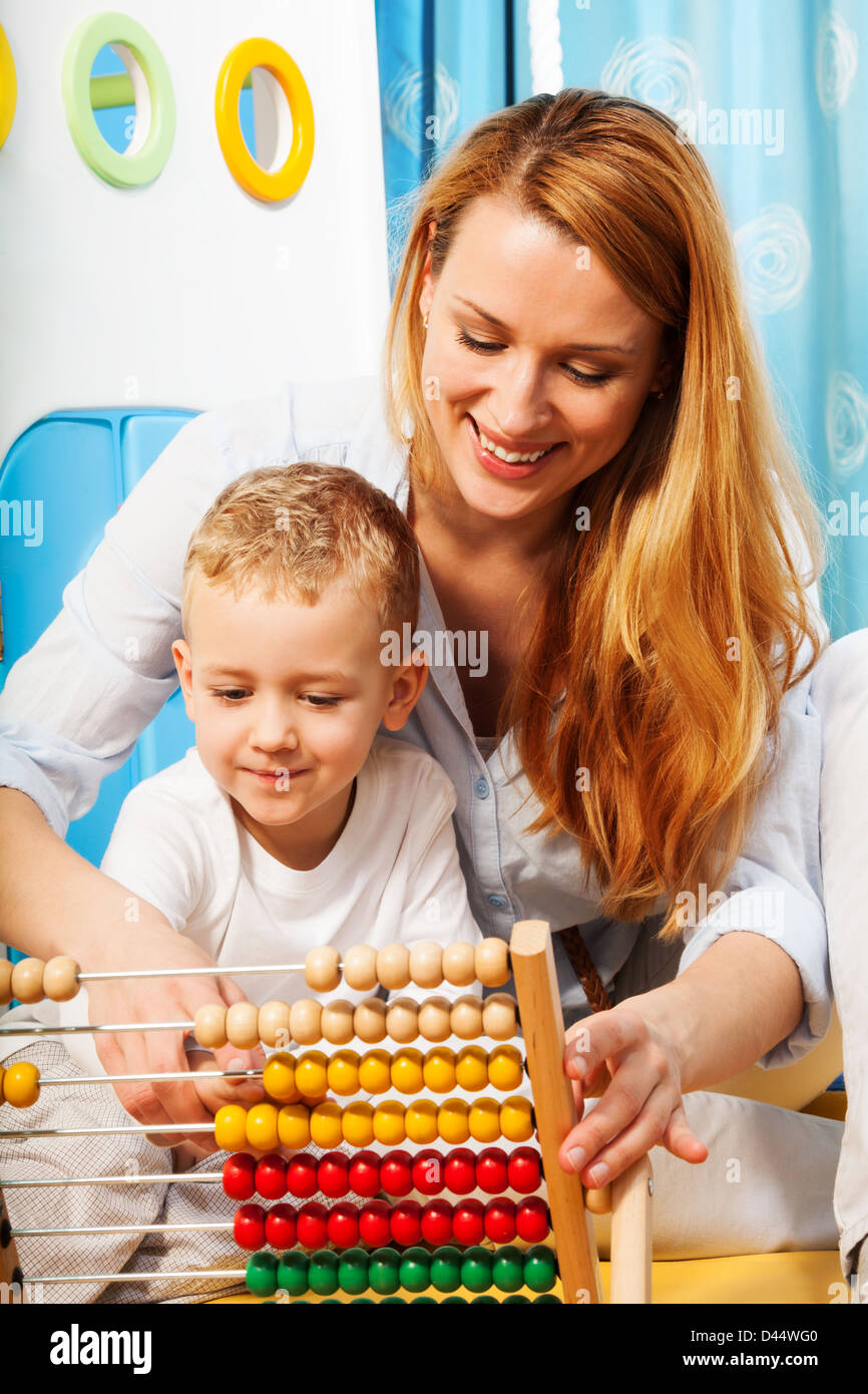 Mother and her little son learning math with abacus Stock Photo - Alamy