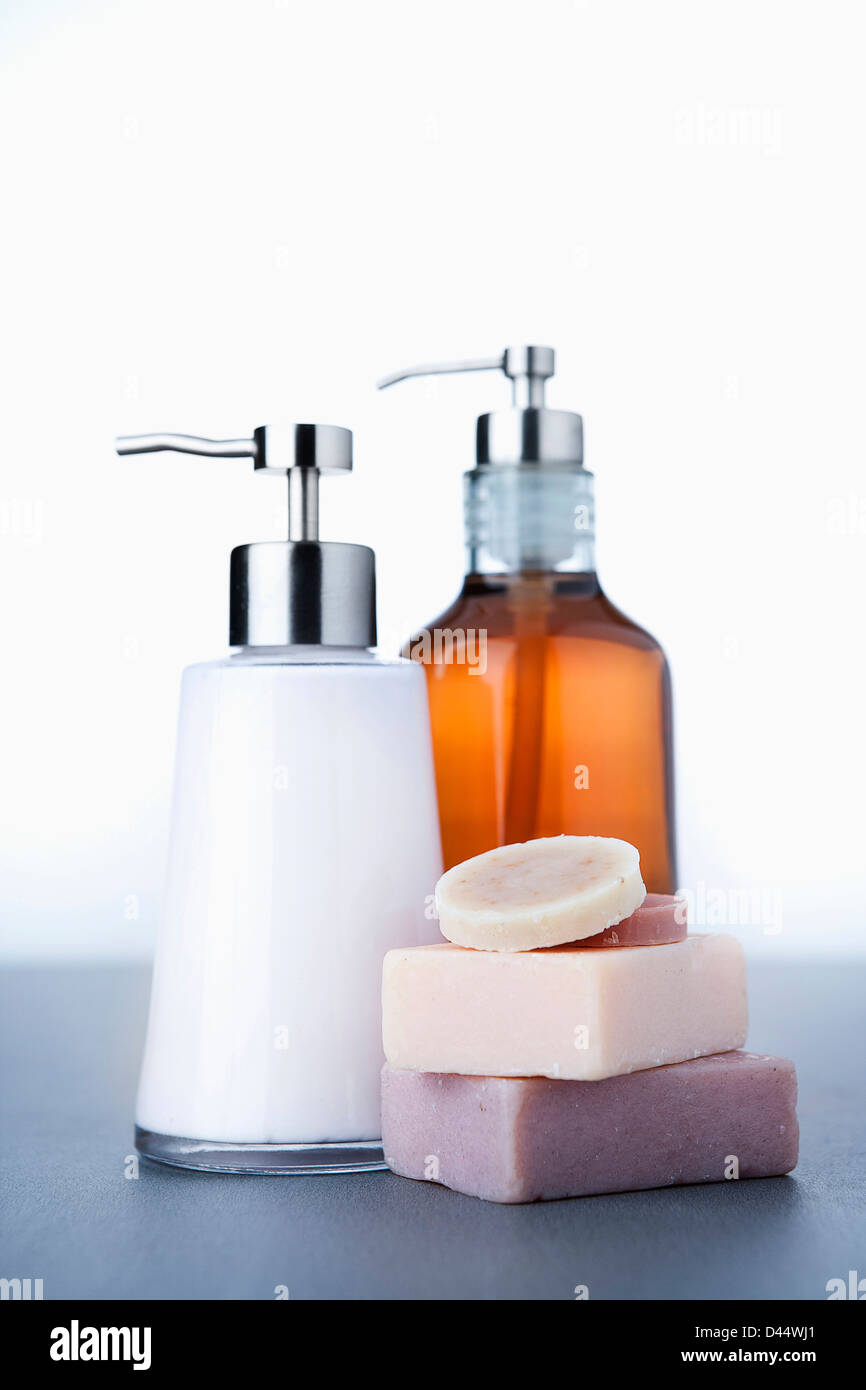 bottles filled with bathing materials next to a pile of soaps Stock ...