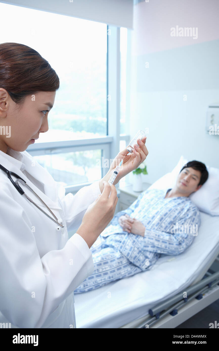 Doctor getting ready give injection hi-res stock photography and images ...