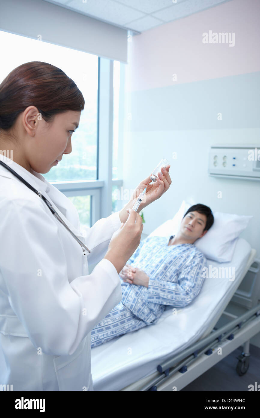 Doctor getting ready give injection hi-res stock photography and images ...