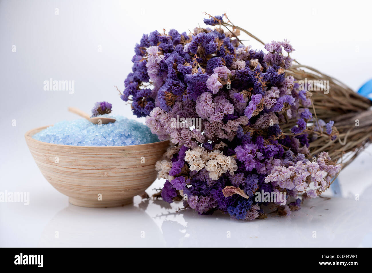 bathing crystals in a bowl next to a bundle of flowers Stock Photo - Alamy