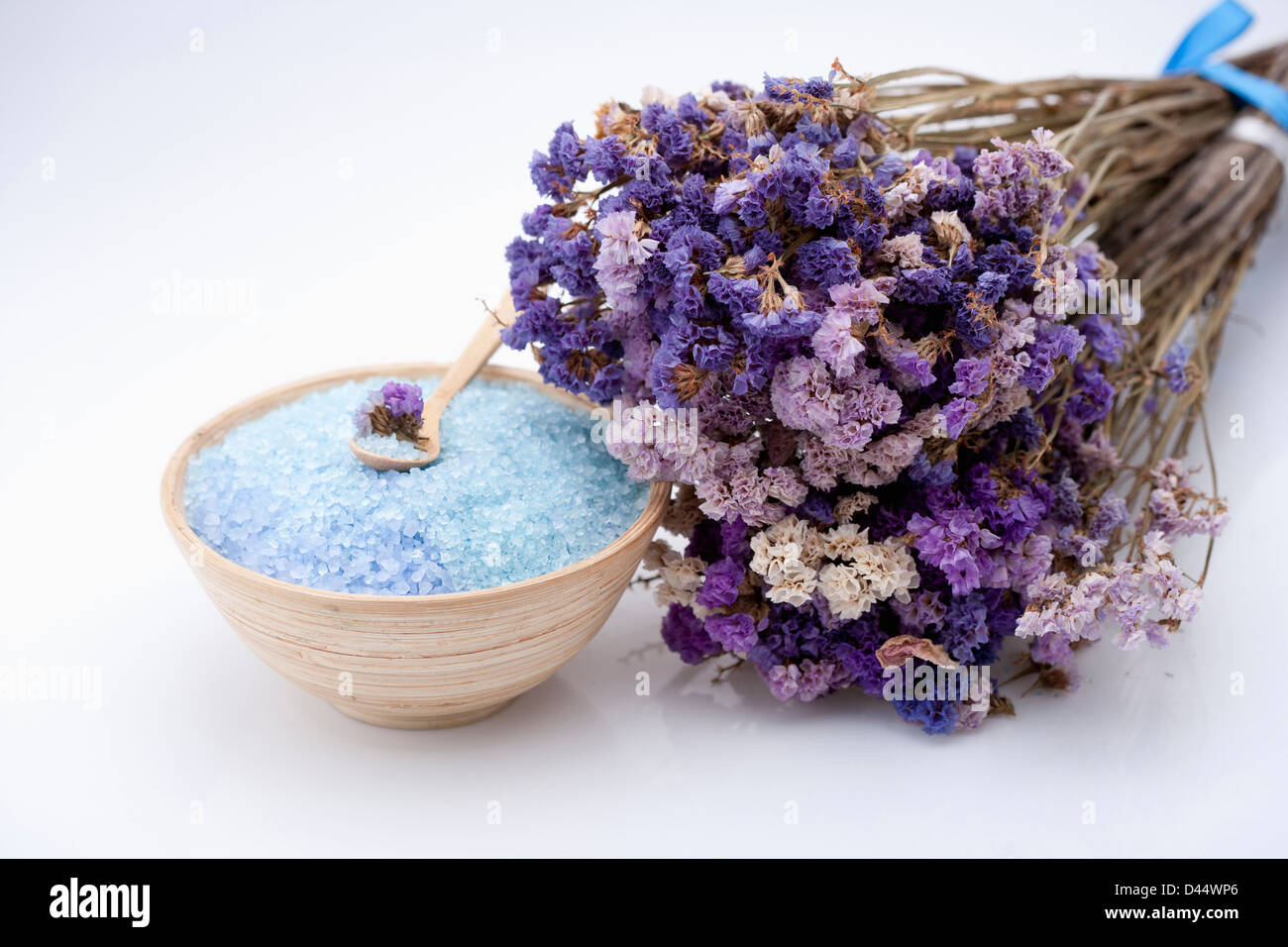 bathing crystals in a bowl next to a bundle of flowers Stock Photo - Alamy