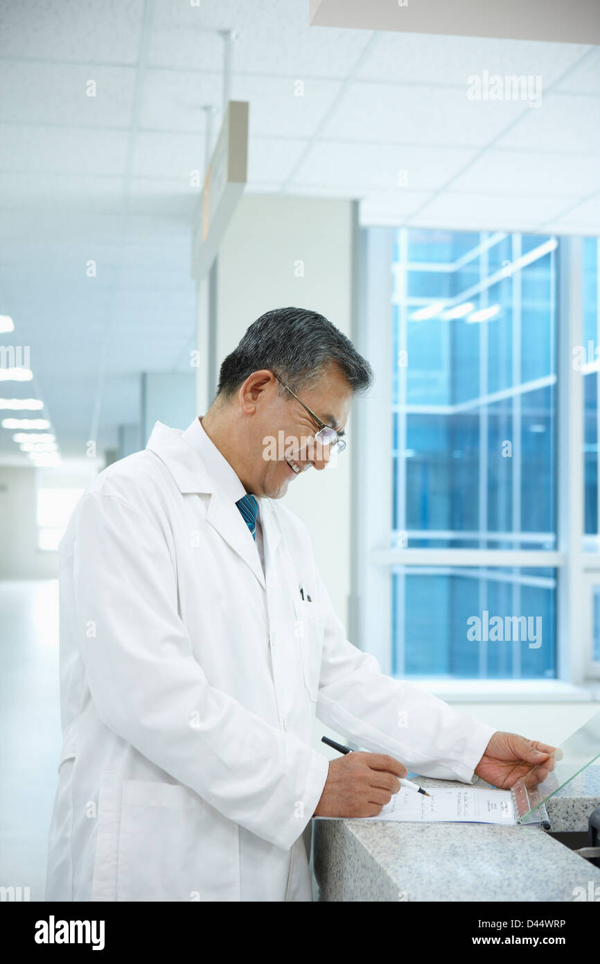 a doctor reviewing the papers in hospital corridor Stock Photo - Alamy
