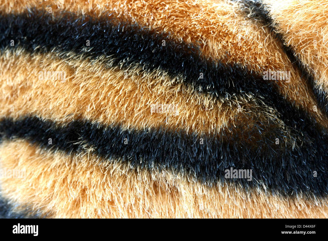 Artificial tiger fur texture detail view Stock Photo - Alamy
