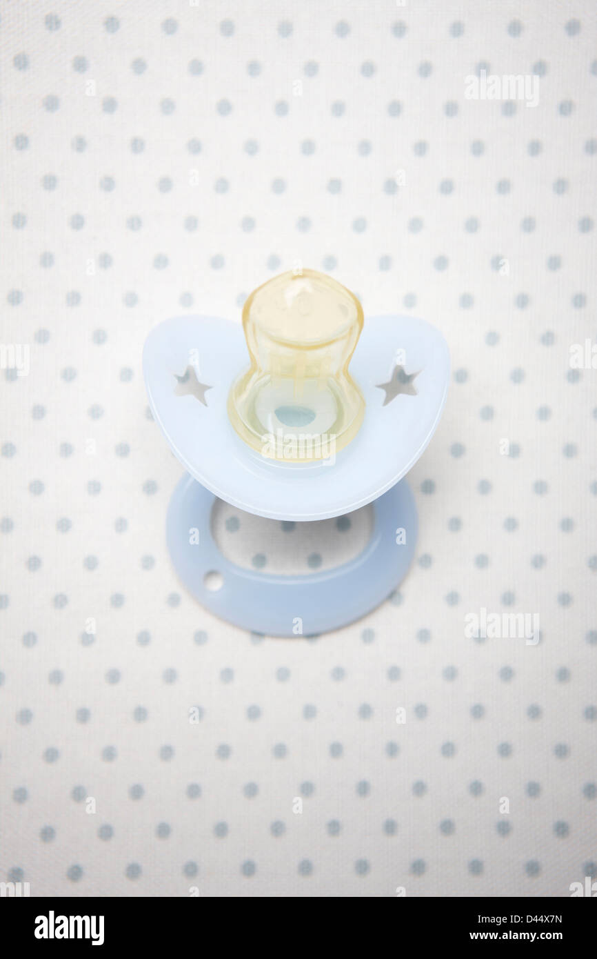 pacifier on dotted background Stock Photo - Alamy