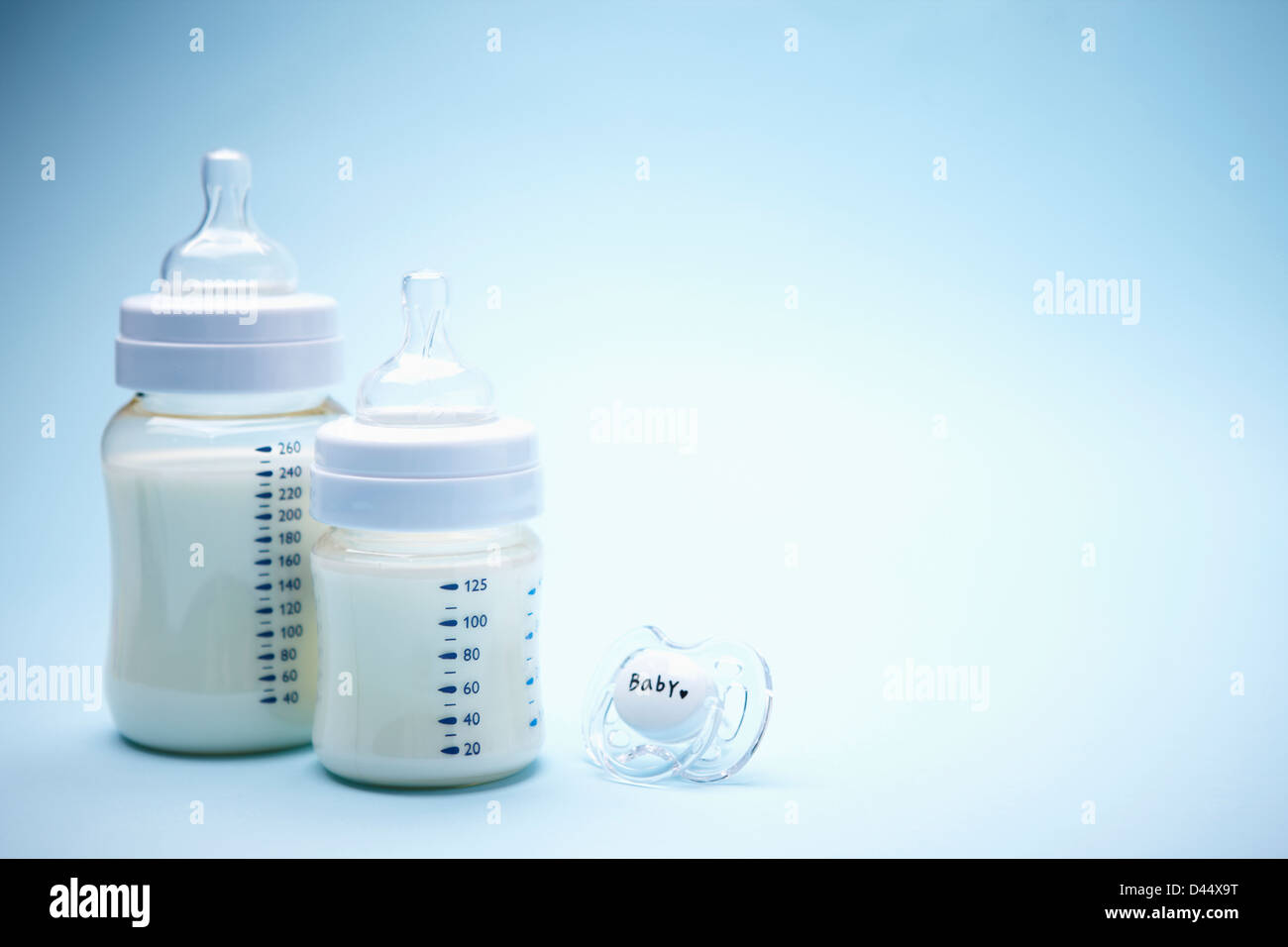 baby's milk bottles and a pacifier Stock Photo - Alamy