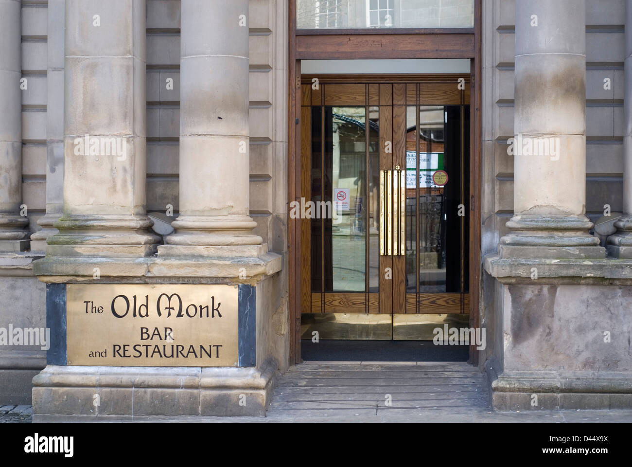 Soft gold light falling on The Old Monk Bar & Restaurant sign and grand ...